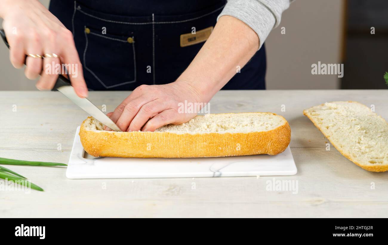 the cook cuts fresh ciabatta bread. Pulls out the pulp from the inside ...