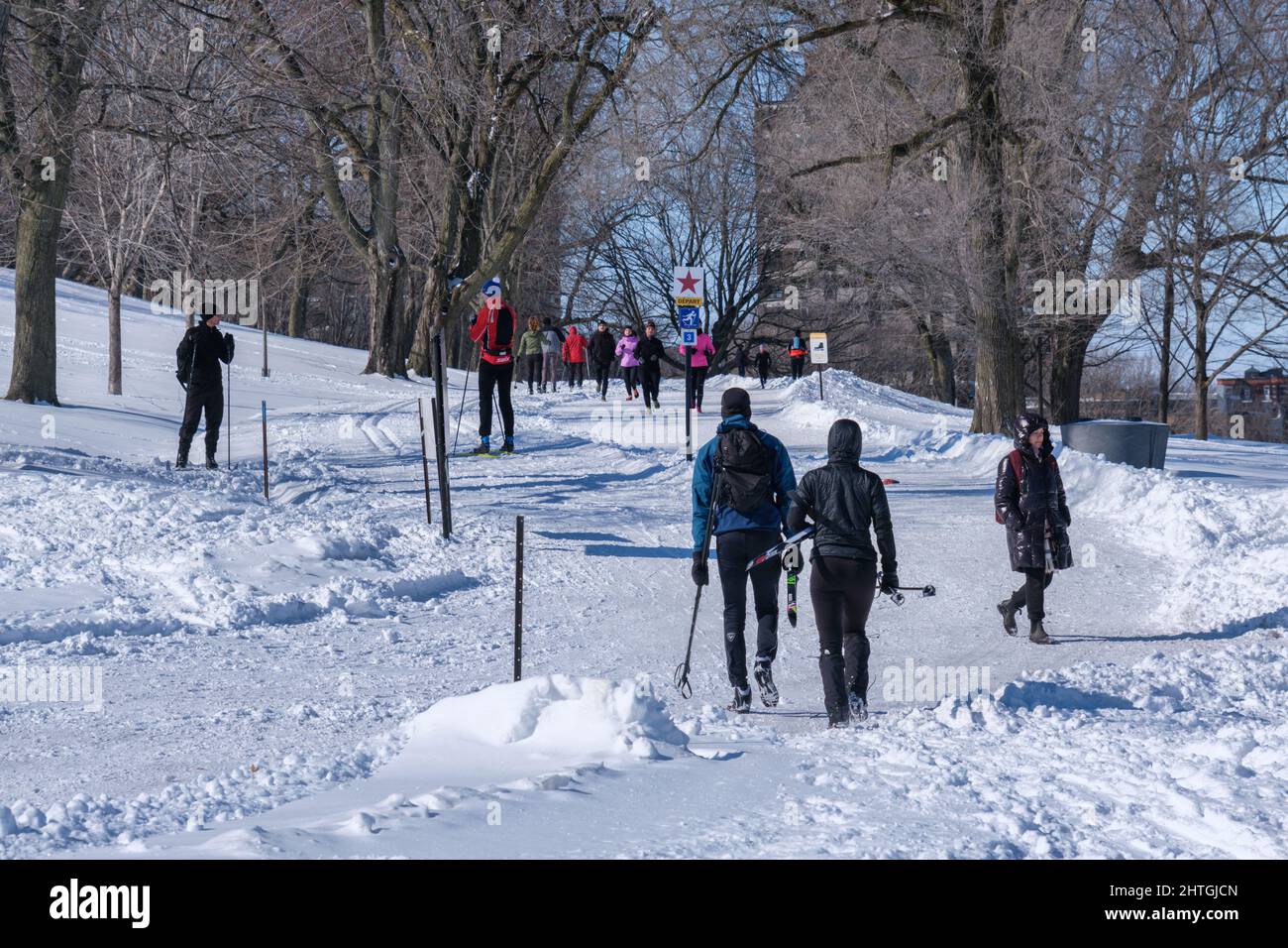 Montreal, CA - 26 February 2022: People walking or skiing on a snowy ...
