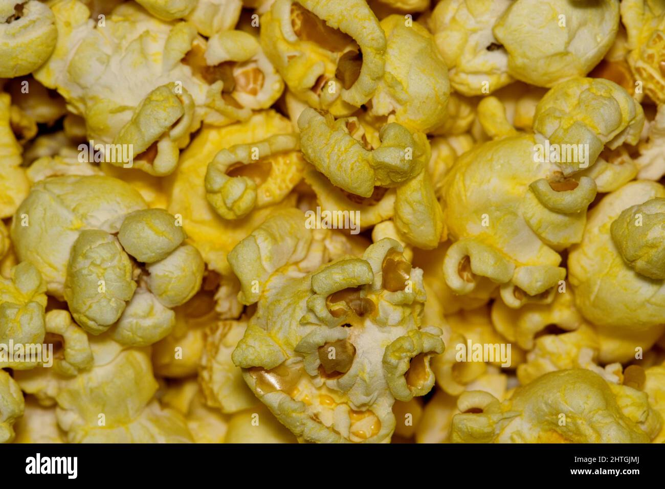 Yellow cheese flavored popcorn kernels up close with details and ...