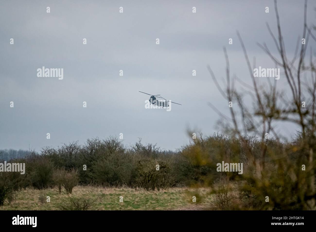 RAF Chinook tandem-rotor CH-47 helicopter flying fast and low in a ...