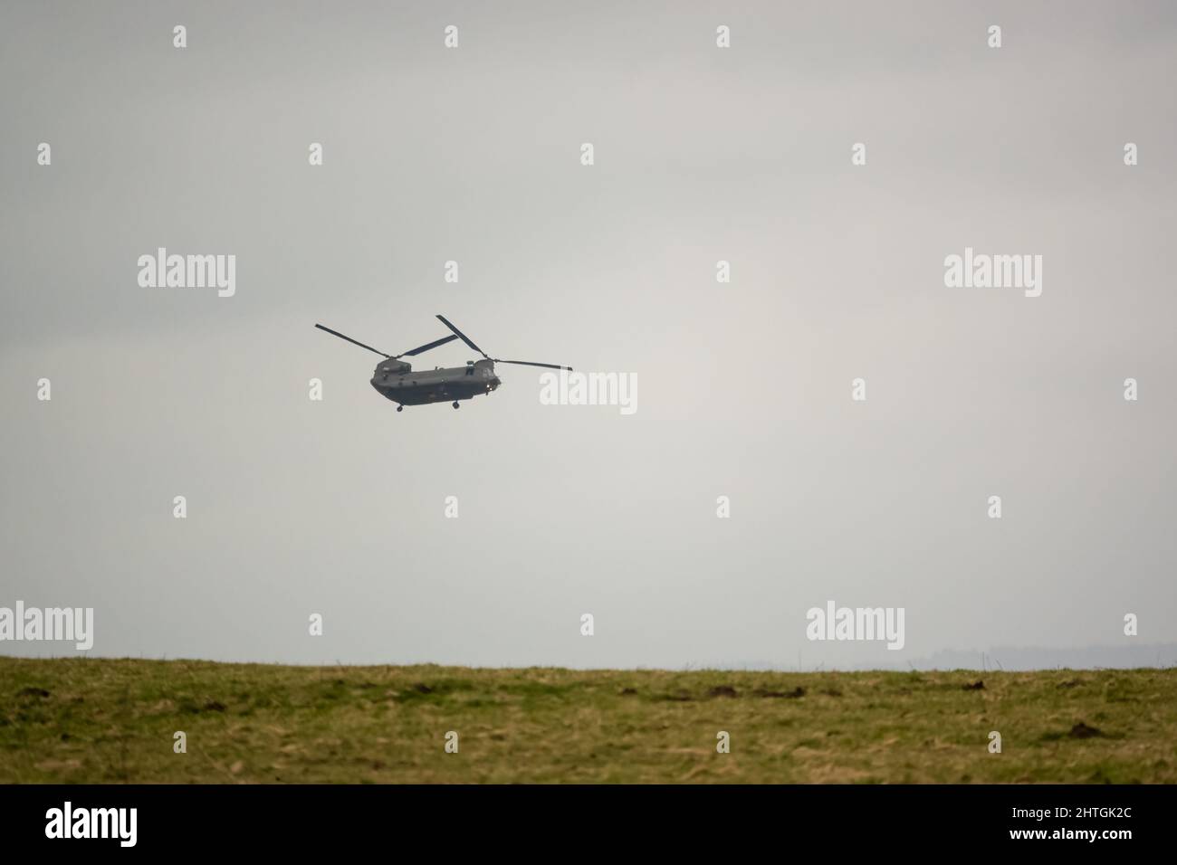 RAF Chinook tandem-rotor CH-47 helicopter flying fast and low in a ...