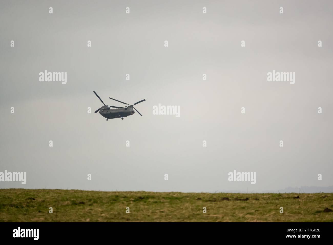 RAF Chinook tandem-rotor CH-47 helicopter flying fast and low in a ...