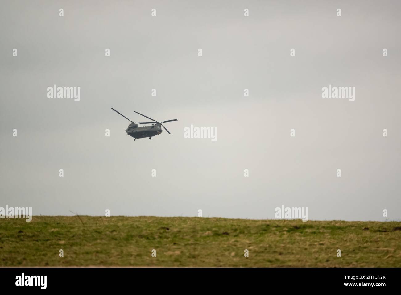 RAF Chinook tandem-rotor CH-47 helicopter flying fast and low in a ...