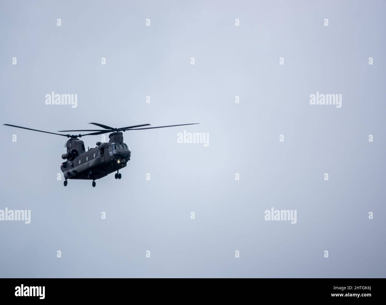 RAF Chinook tandem-rotor CH-47 helicopter flying fast and low in a ...