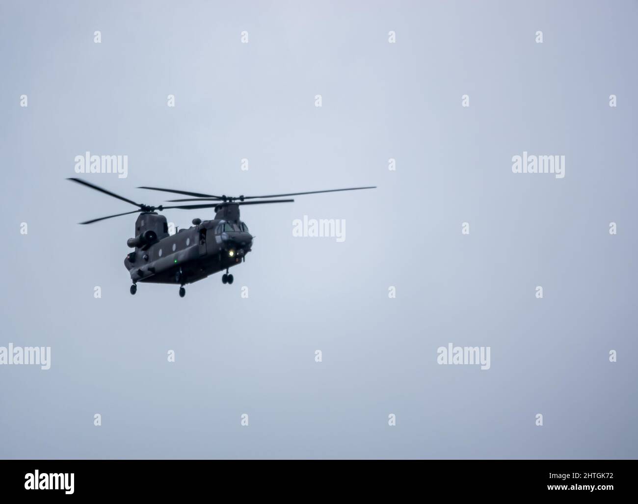 RAF Chinook tandem-rotor CH-47 helicopter flying fast and low in a ...