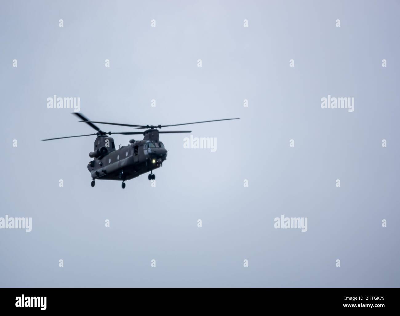RAF Chinook tandem-rotor CH-47 helicopter flying fast and low in a ...