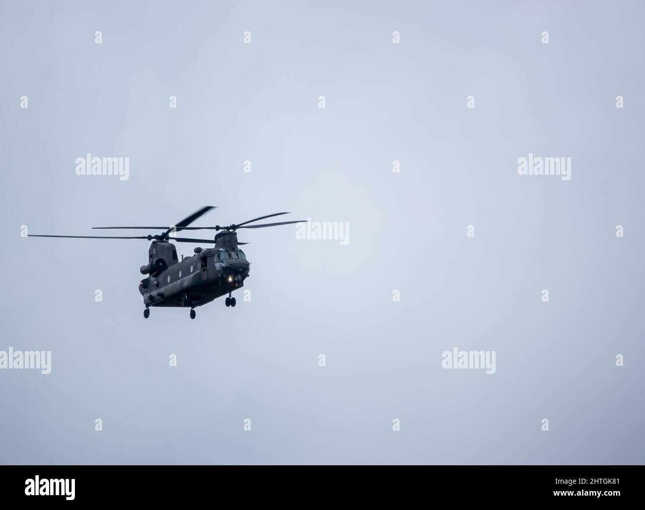 RAF Chinook tandem-rotor CH-47 helicopter flying fast and low in a ...