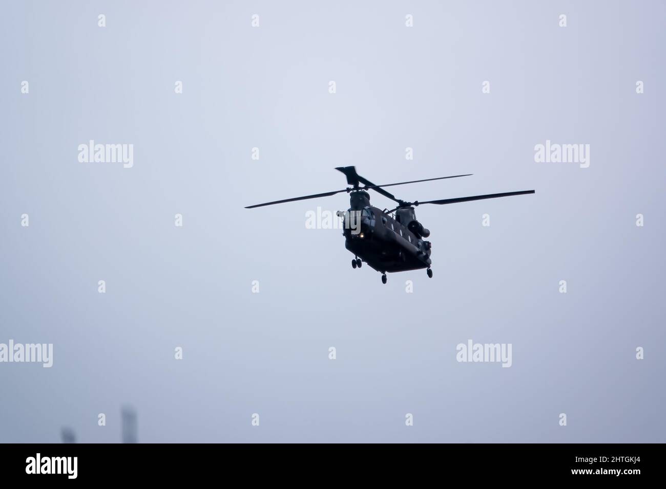 RAF Chinook tandem-rotor CH-47 helicopter flying fast and low in a ...