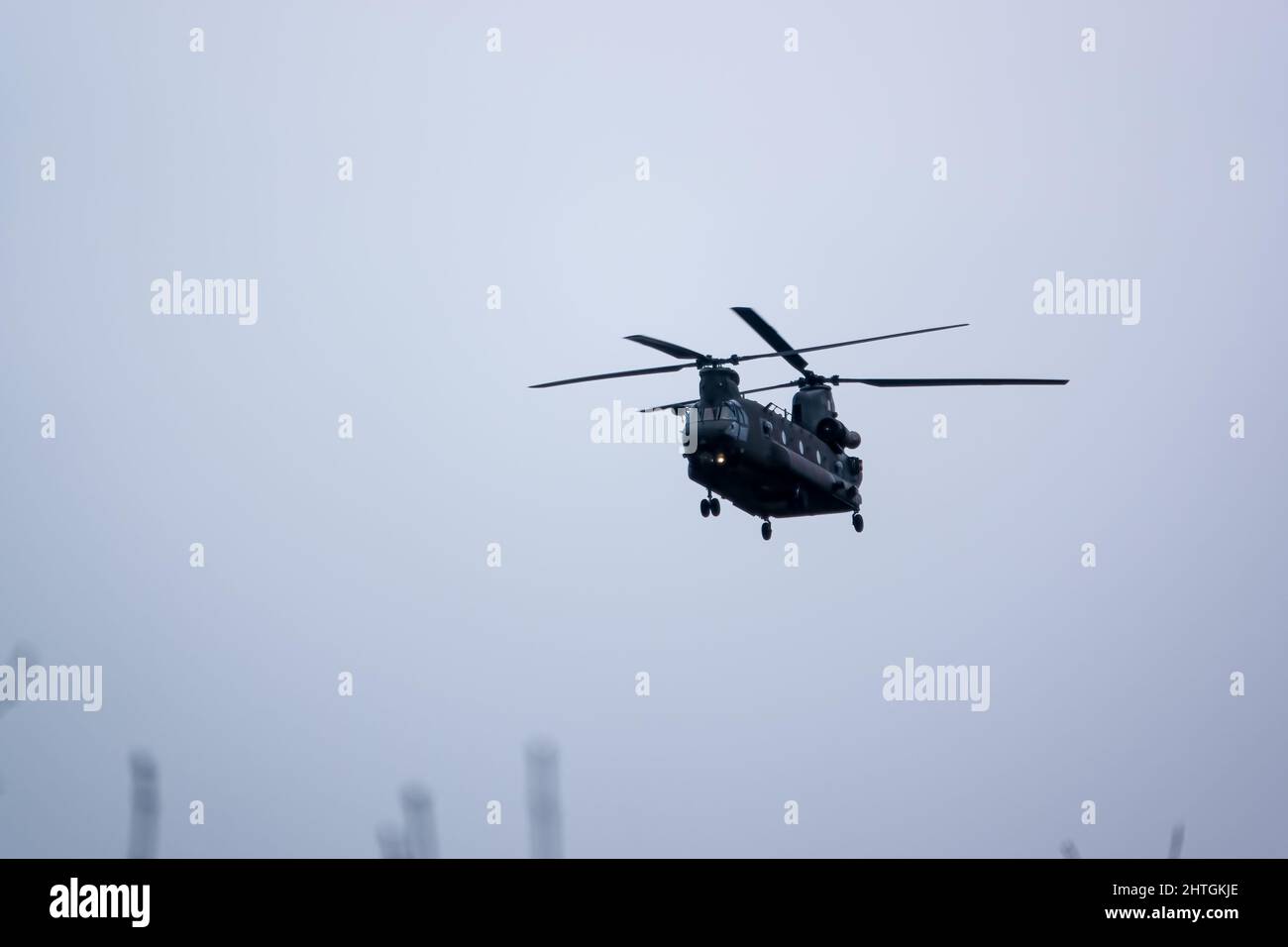 RAF Chinook tandem-rotor CH-47 helicopter flying fast and low in a ...