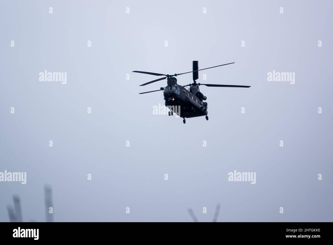 RAF Chinook tandem-rotor CH-47 helicopter flying fast and low in a ...