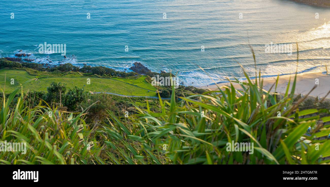 Panoramic view of Green slope leading from summit to base of coastal ...