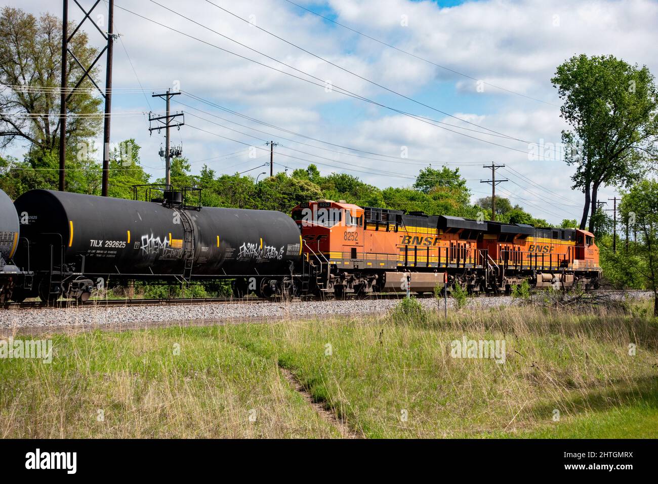 BNSF diesel engines pulling a railroad train with tanker cars in the ...
