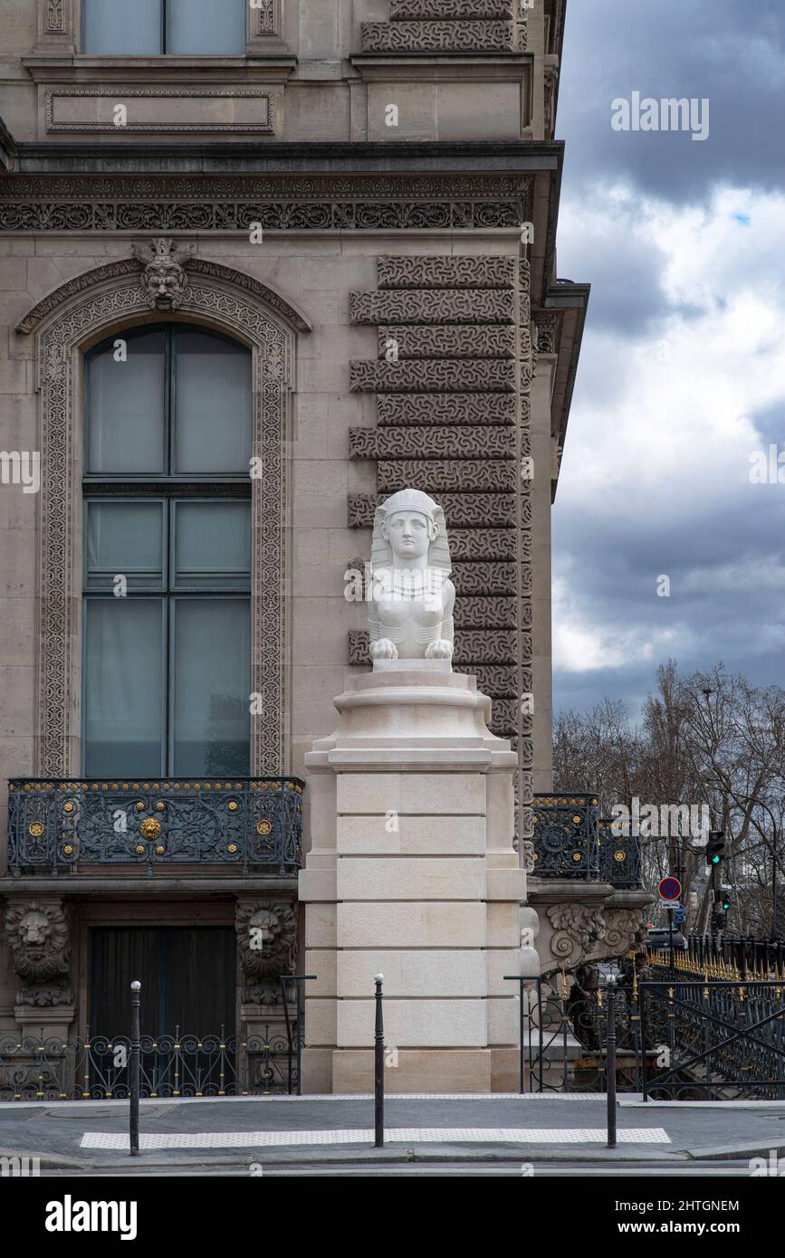 White statue of an Egyptian sphinx in front of the Louvre in Paris ...