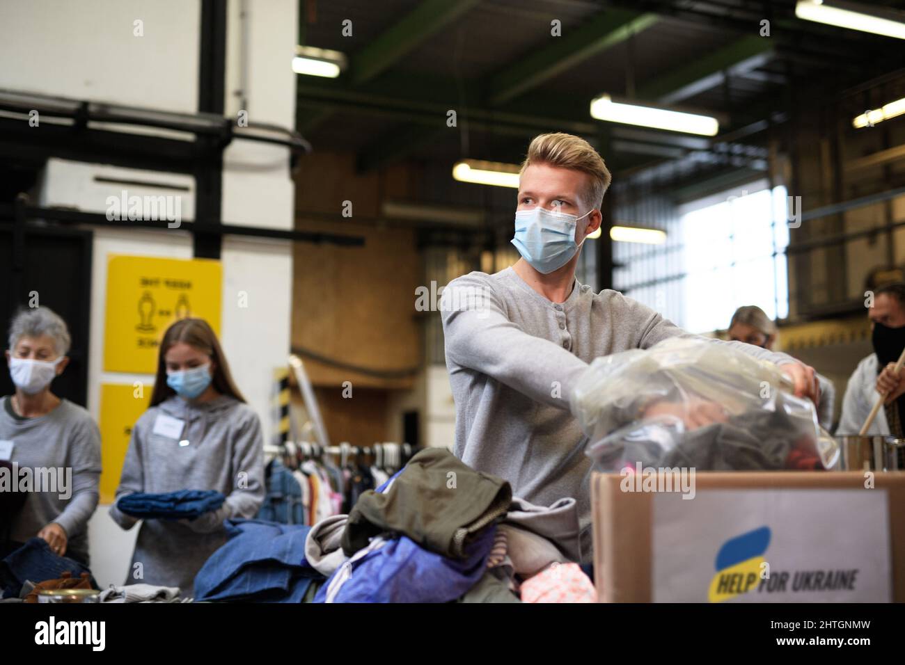 Volunteers sorting out donated clothes for the needs of Ukrainian ...