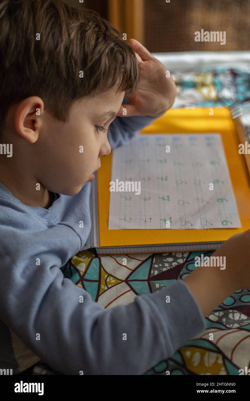 angry toddler while doing school homework writing numbers Stock Photo ...