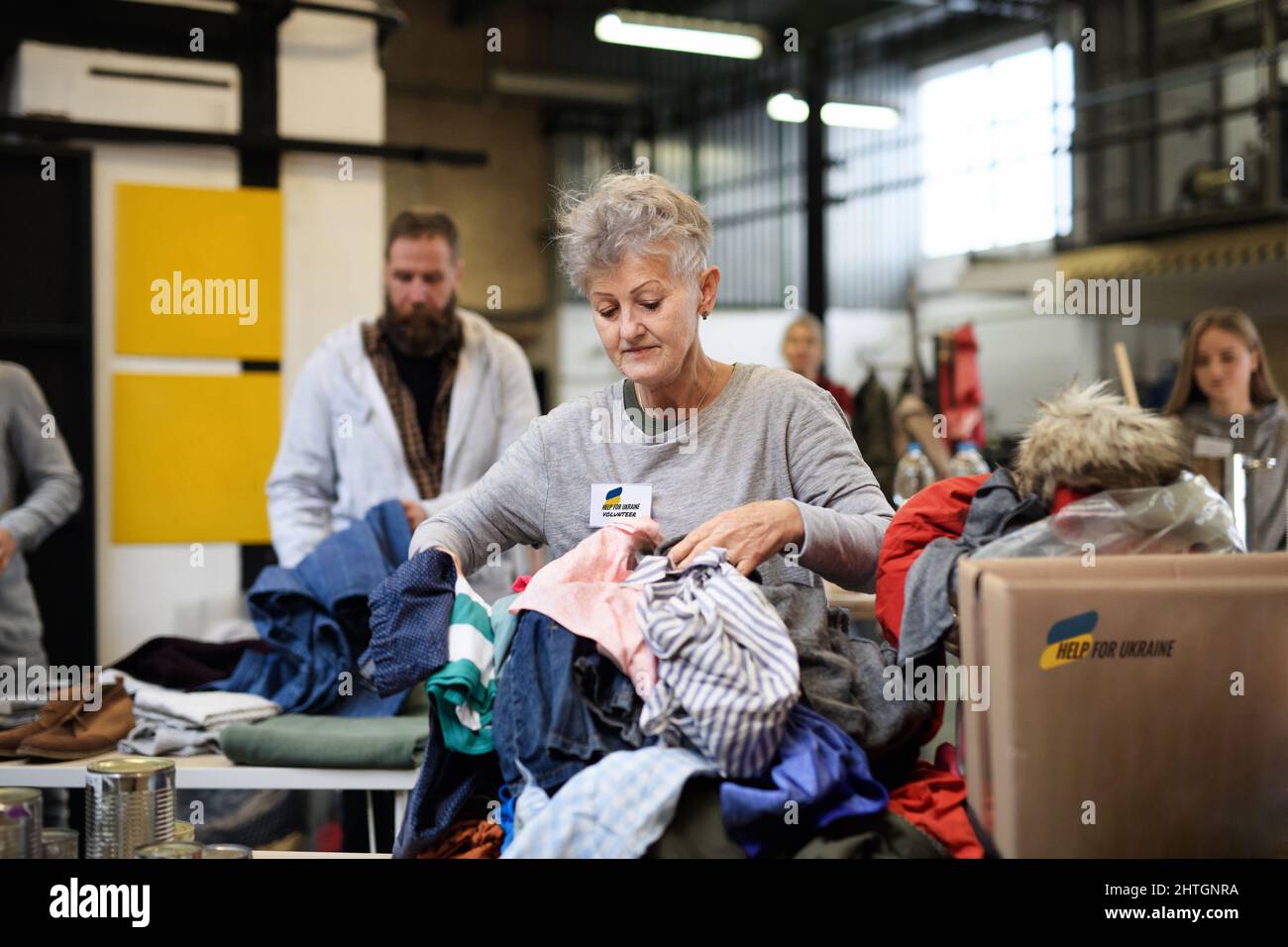 Volunteers sorting out donated clothes for the needs of Ukrainian ...