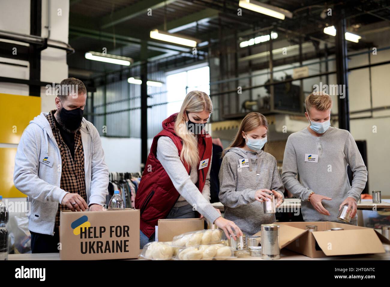 Volunteers sorting out donated food for the needs of Ukrainian migrants ...