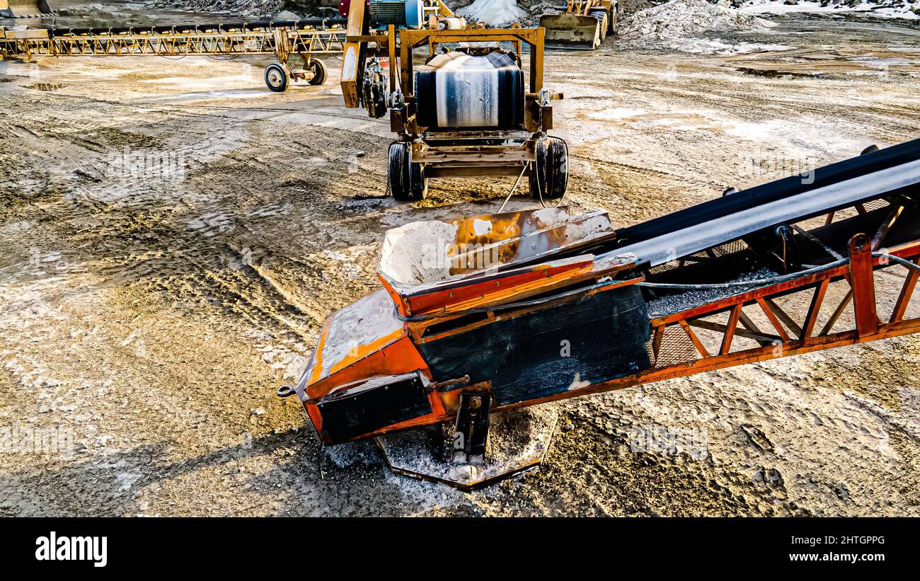 Open pit rock quarry with stone traveling on conveyors to piles Stock ...