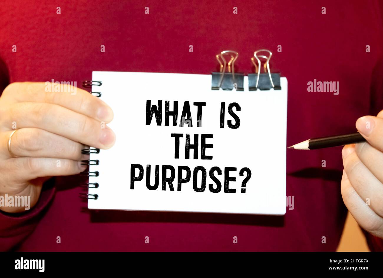 Notebook ,pencils,pen and rubber band with text WHAT IS THE PURPOSE on ...