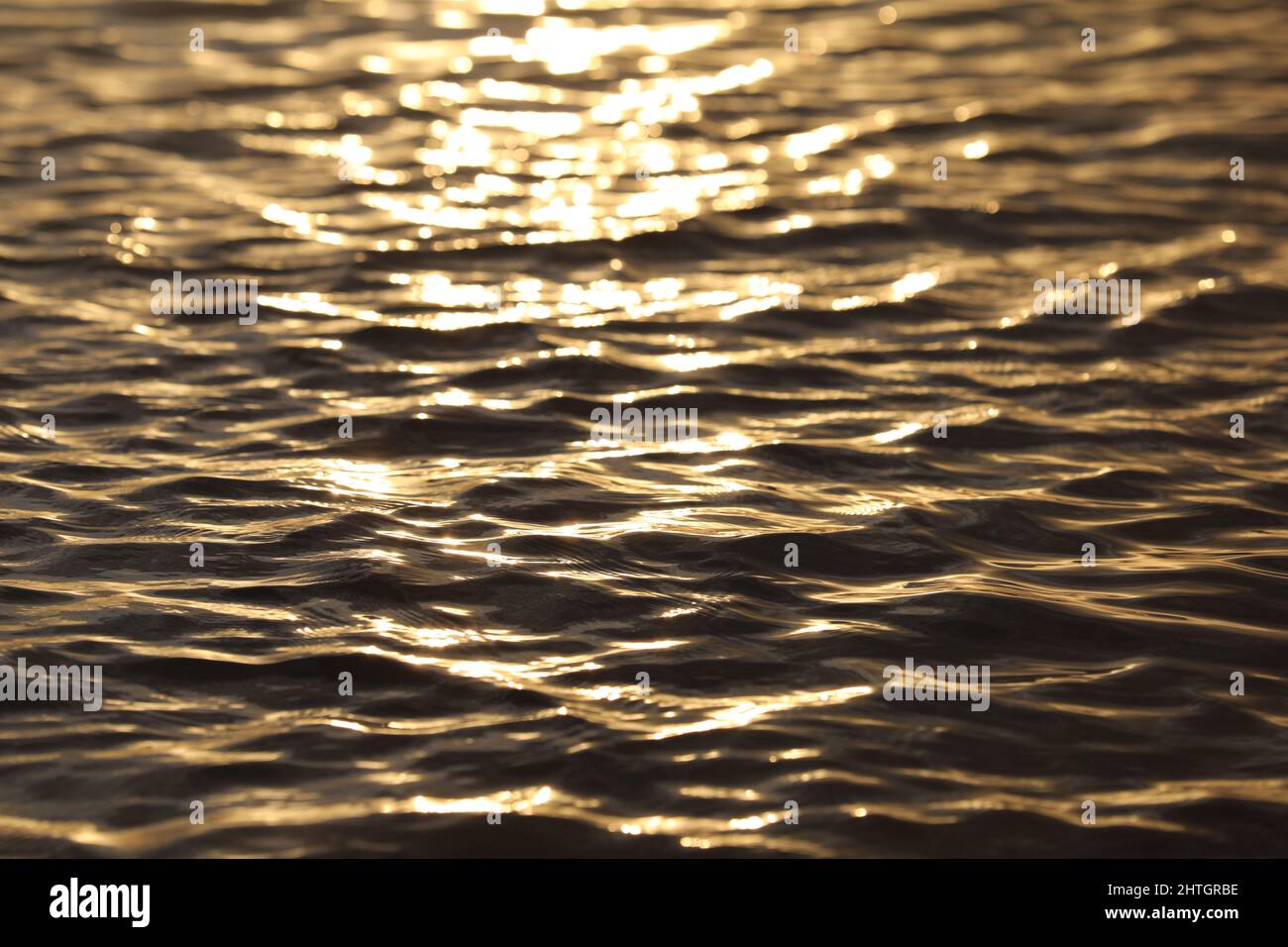 texture of water wave with reflection of sunlight at sunset Stock Photo ...