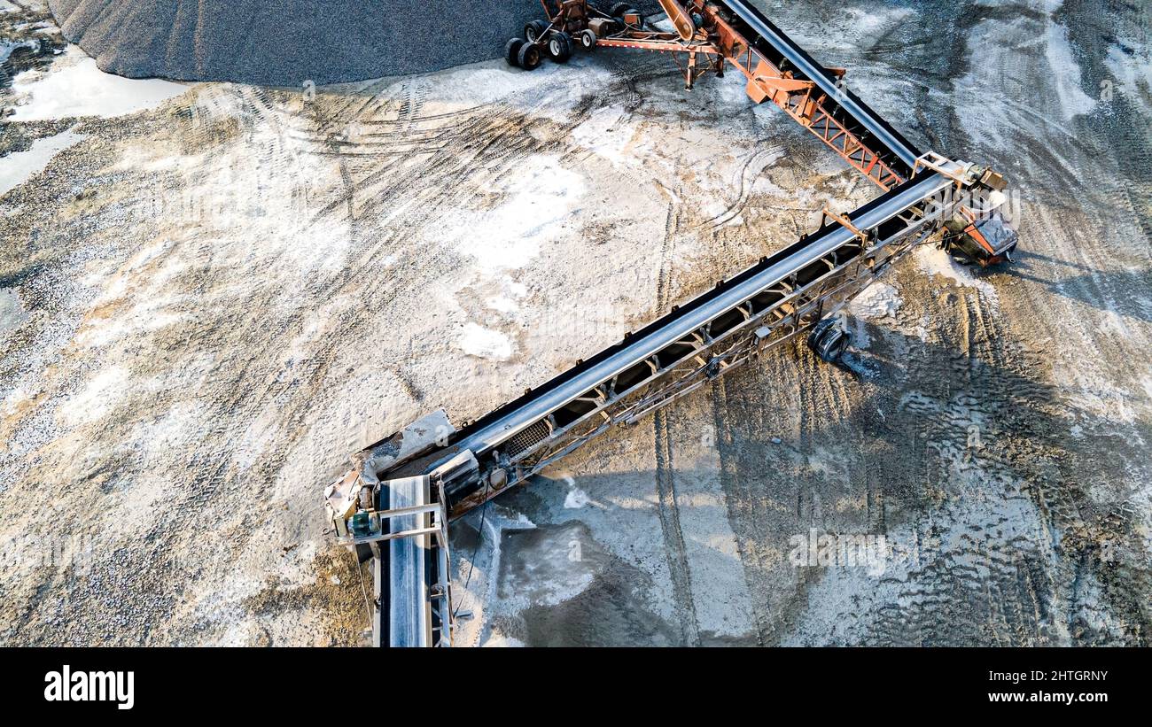 Open pit rock quarry with stone traveling on conveyors to piles Stock ...
