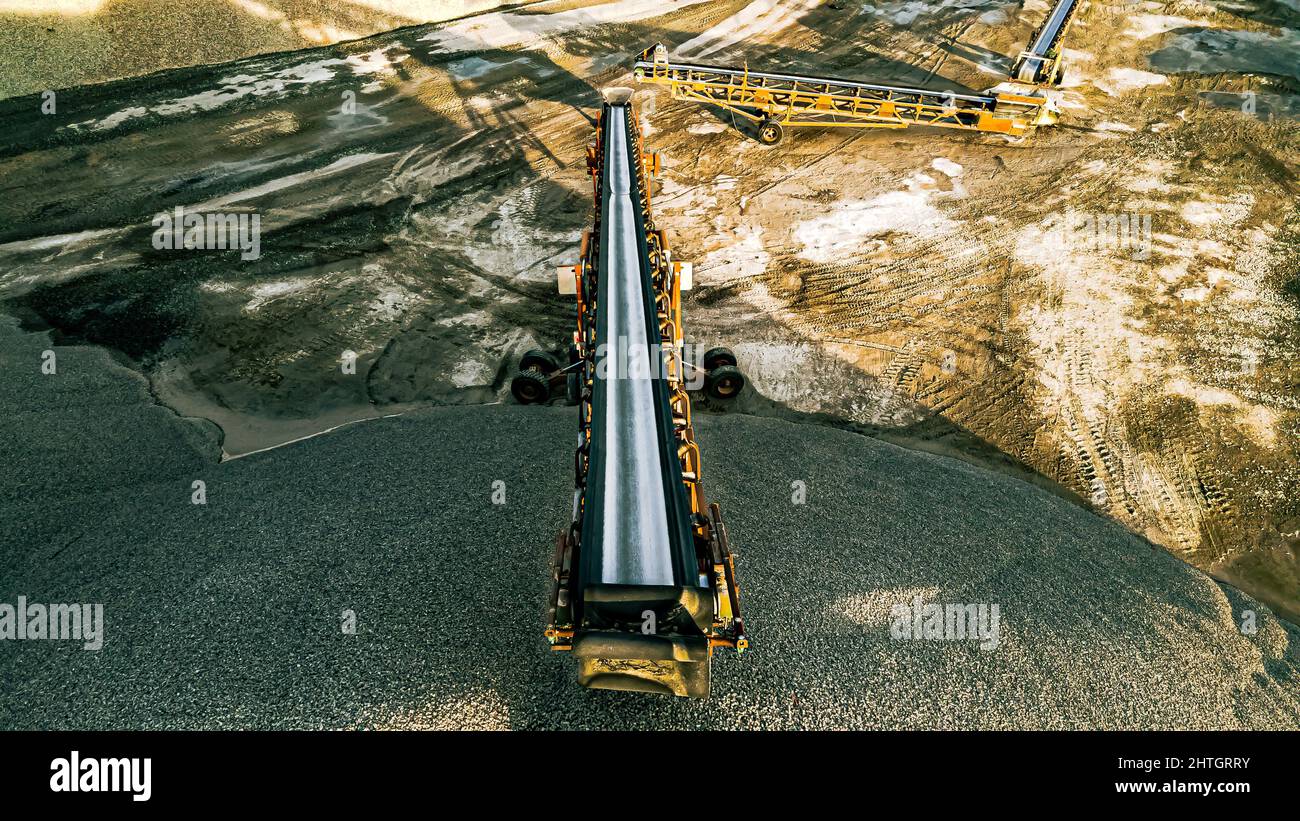 Open pit rock quarry with stone traveling on conveyors to piles Stock ...