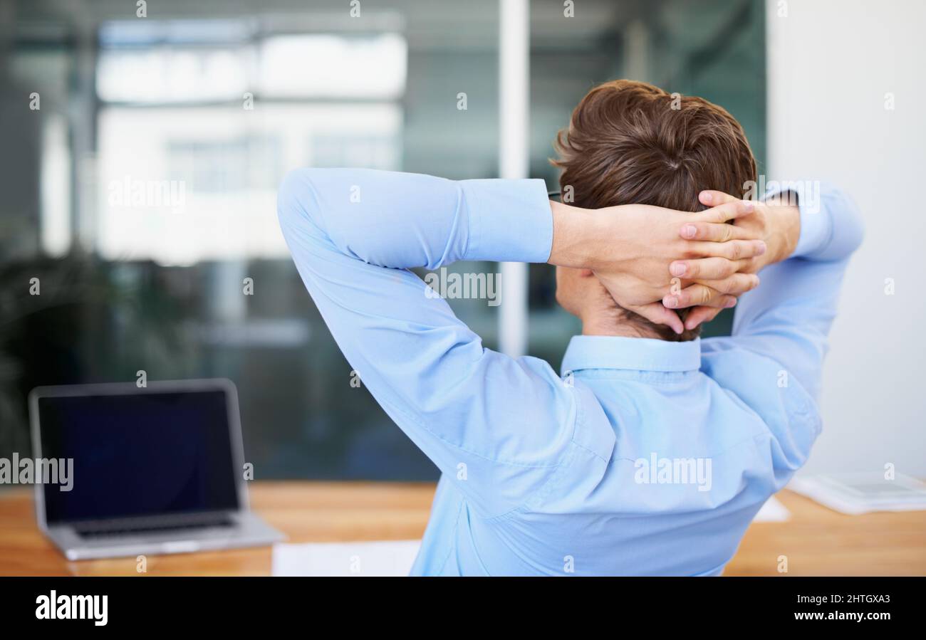 Satisfied with his work for the day. A satisfied young businessman ...