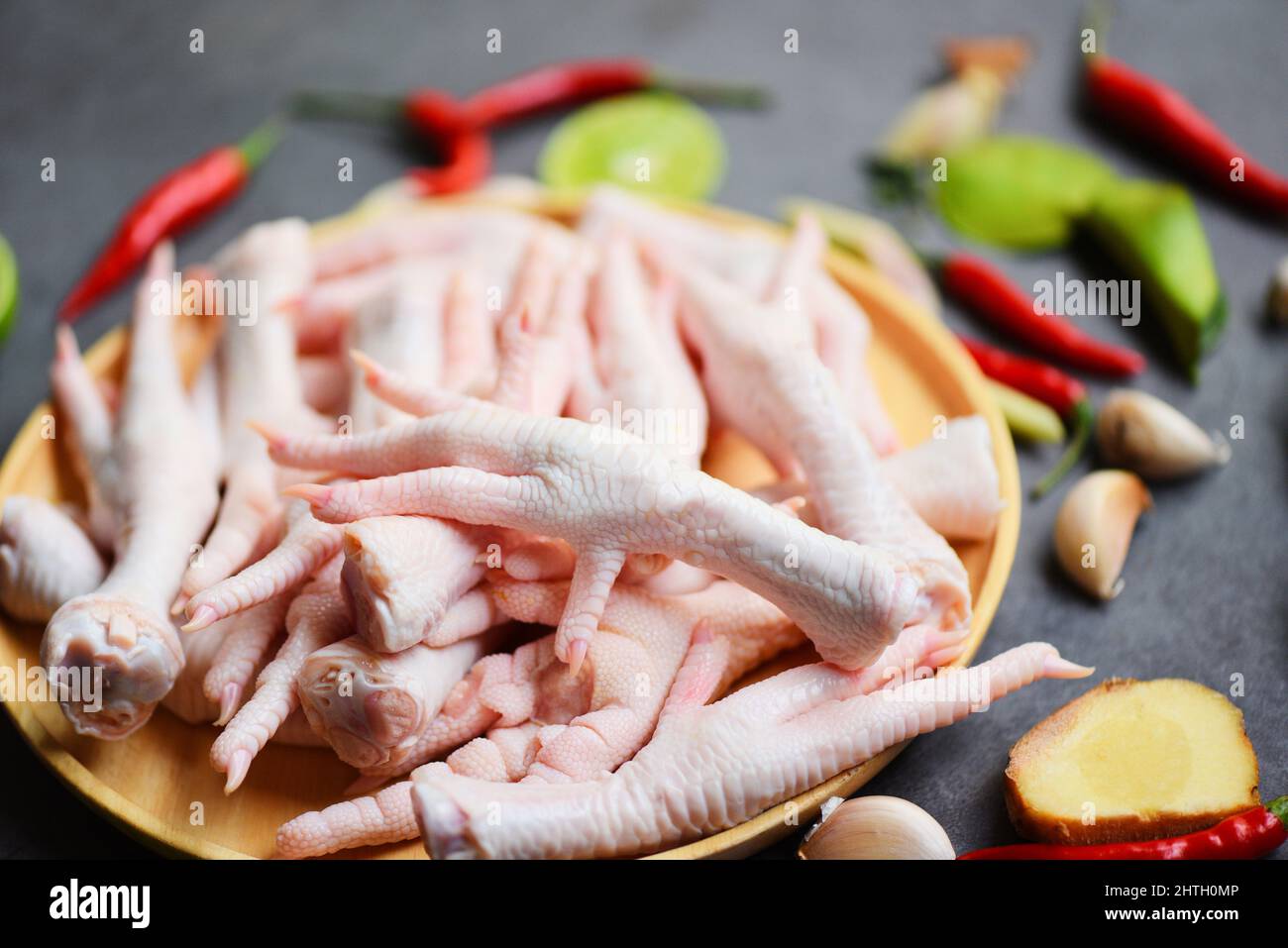 Fresh raw chicken feet for cooked food on the wooden table kitchen ...