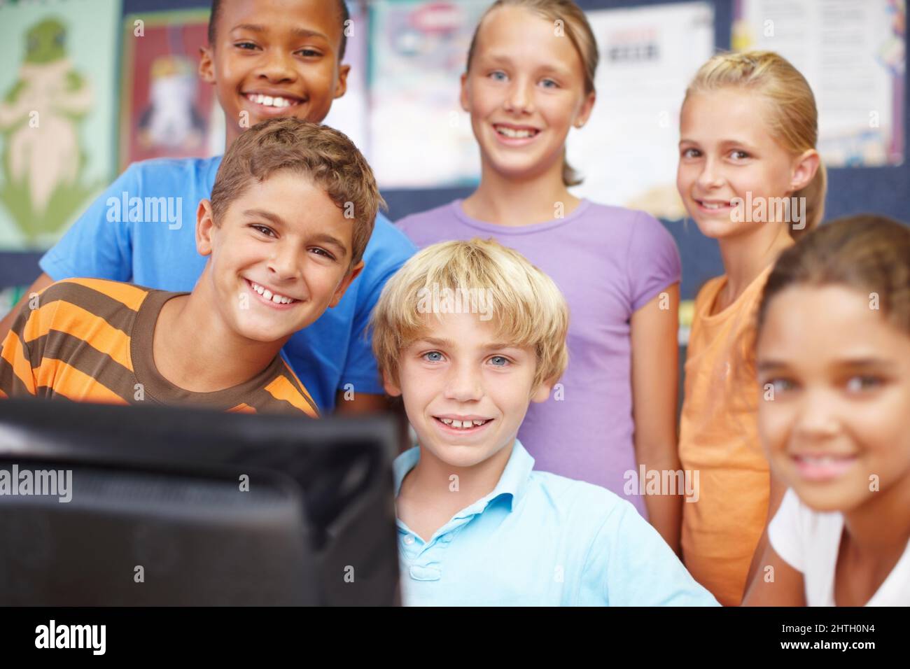 We love computer class. Portrait of a group of cute kids sitting and ...