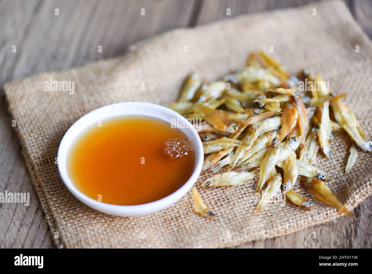 fish sauce on white bowl and small dried fish on sack, fish sauce ...