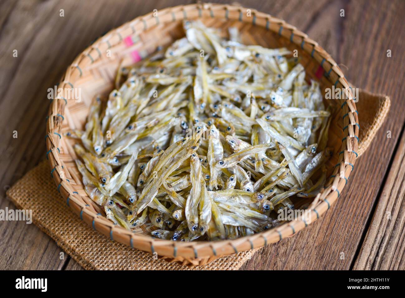 small dried fish on basket and the sack background Stock Photo - Alamy