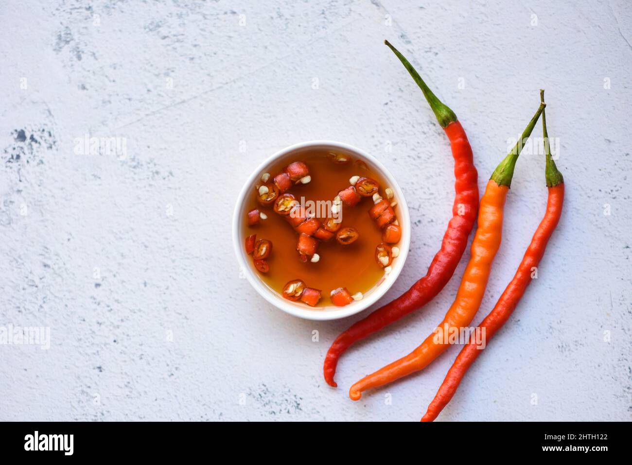 fish sauce on white bowl and fresh chili on table, fish sauce obtained ...
