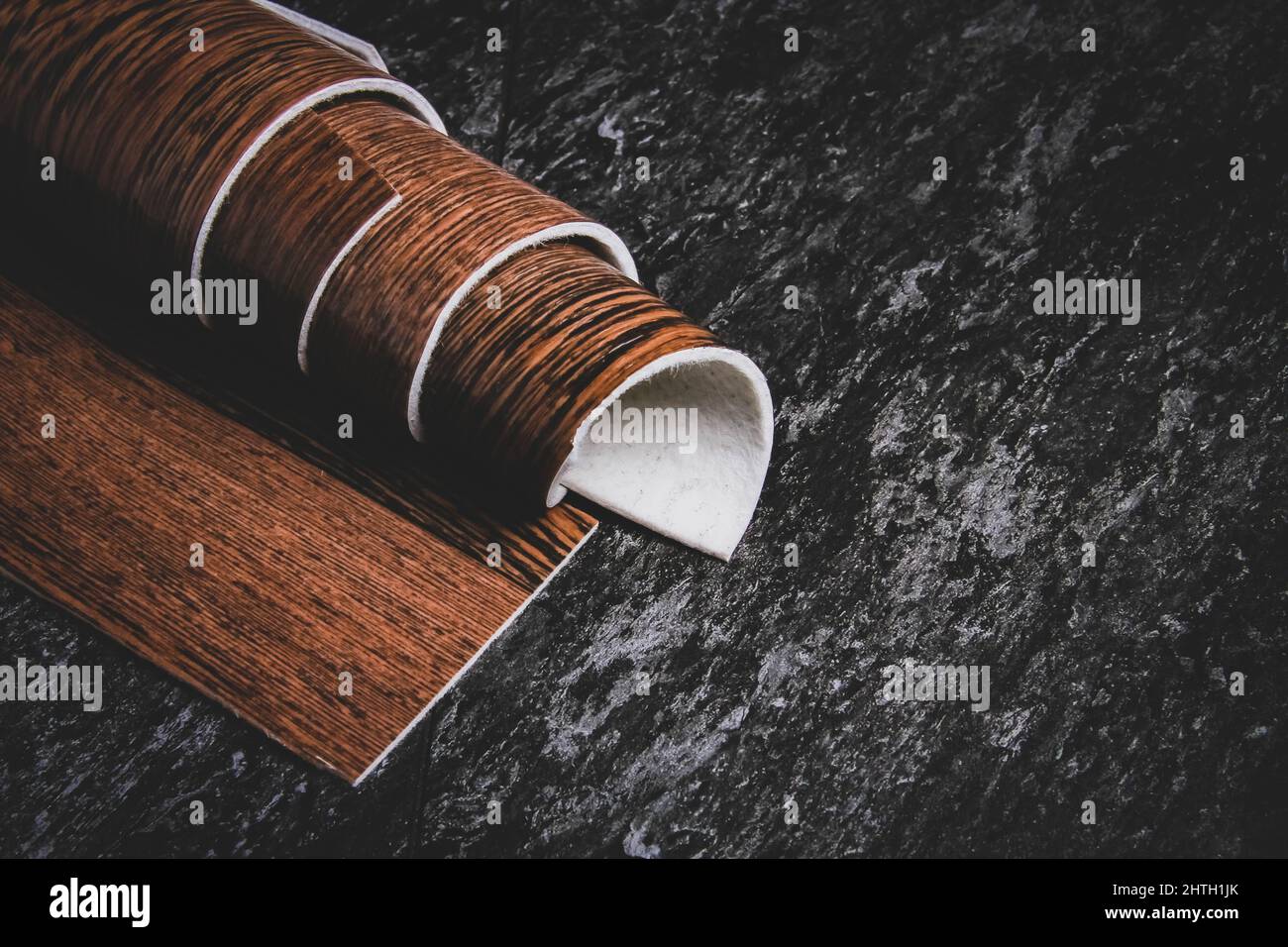 Linoleum. Roll of linoleum on a black background. Floor coverings ...