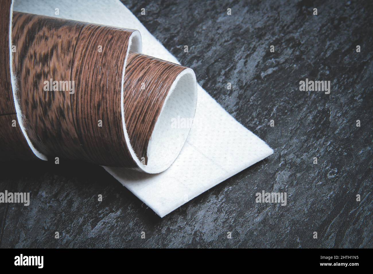 Linoleum. Roll of linoleum on a black background. Floor coverings ...