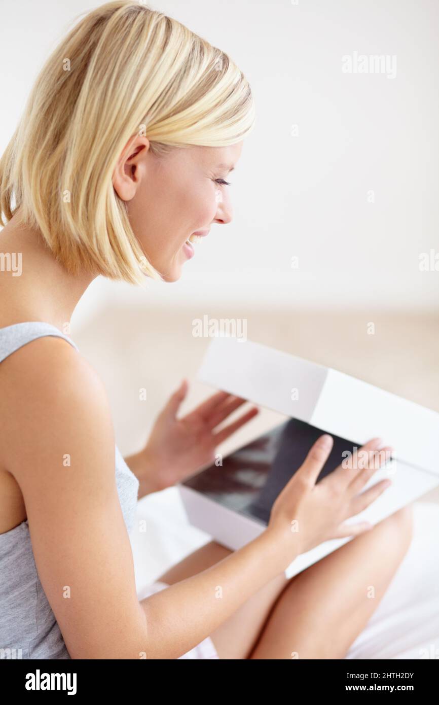 Young blond woman opening box hi-res stock photography and images - Alamy