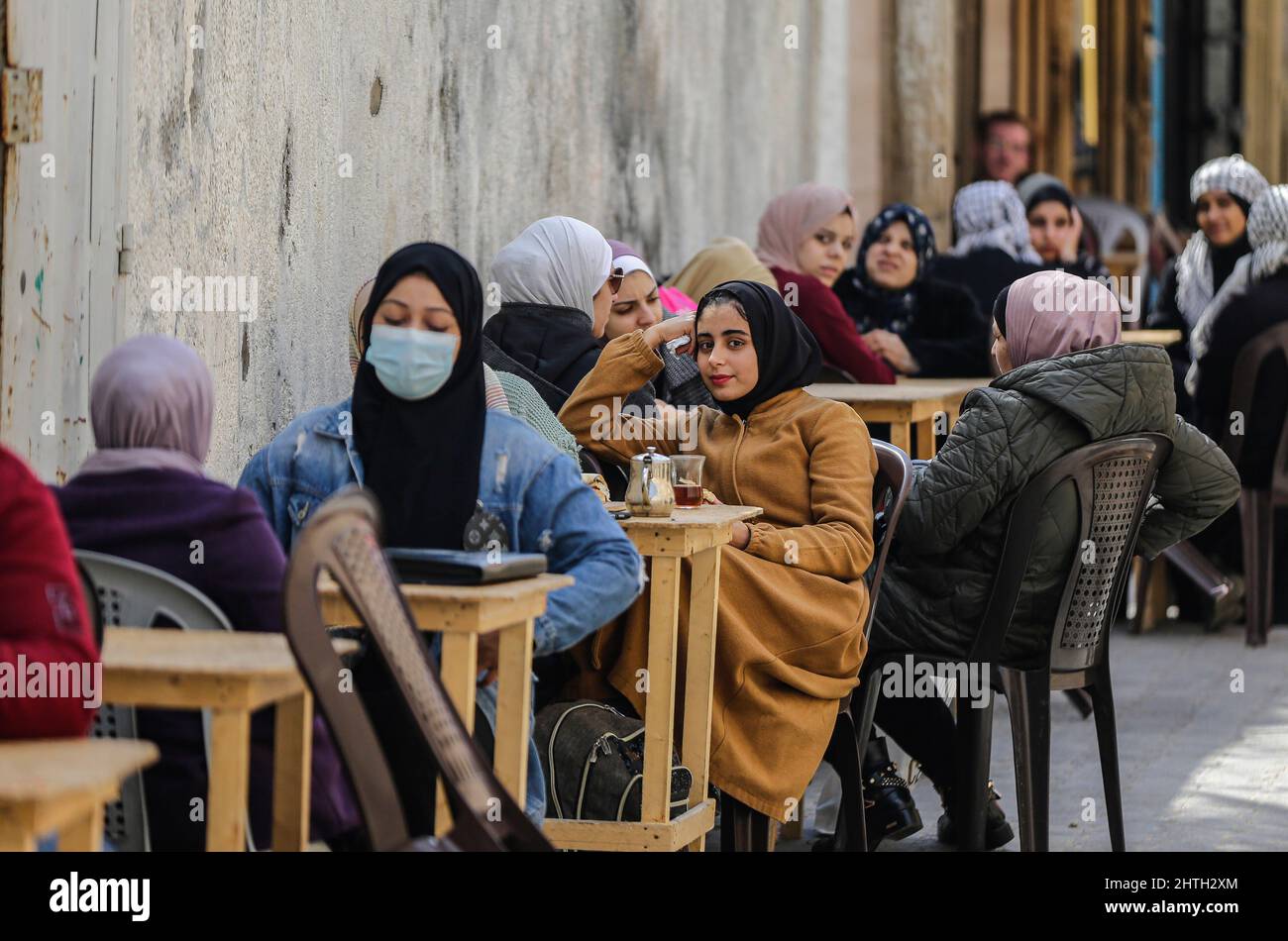 Gaza City, Palestine. 27th Feb, 2022. Palestinians eat food on a street ...