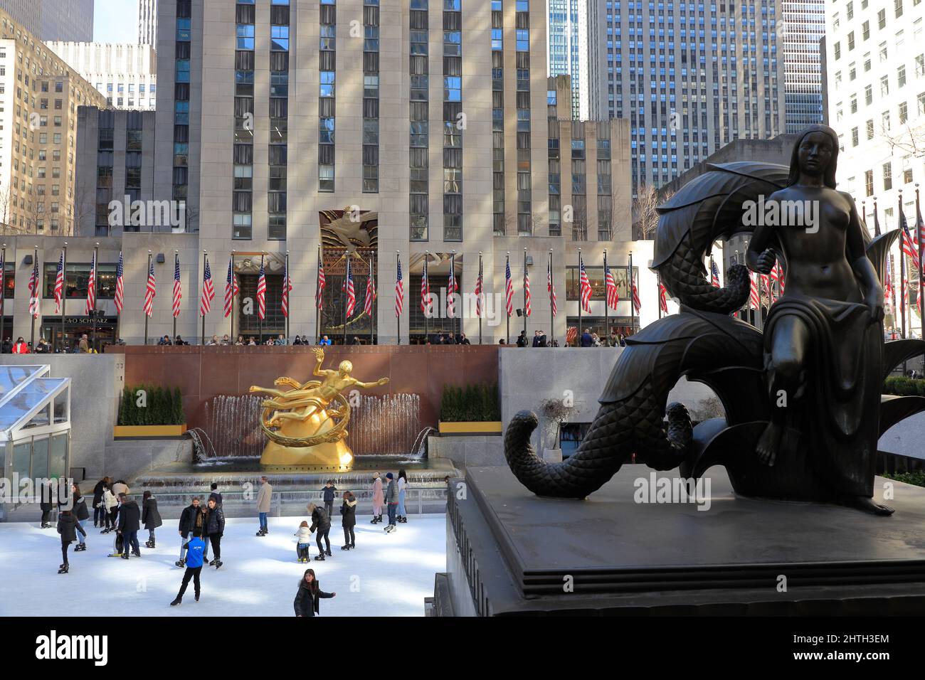 People skating in the Rink At Rockefeller Center with gilded golden ...