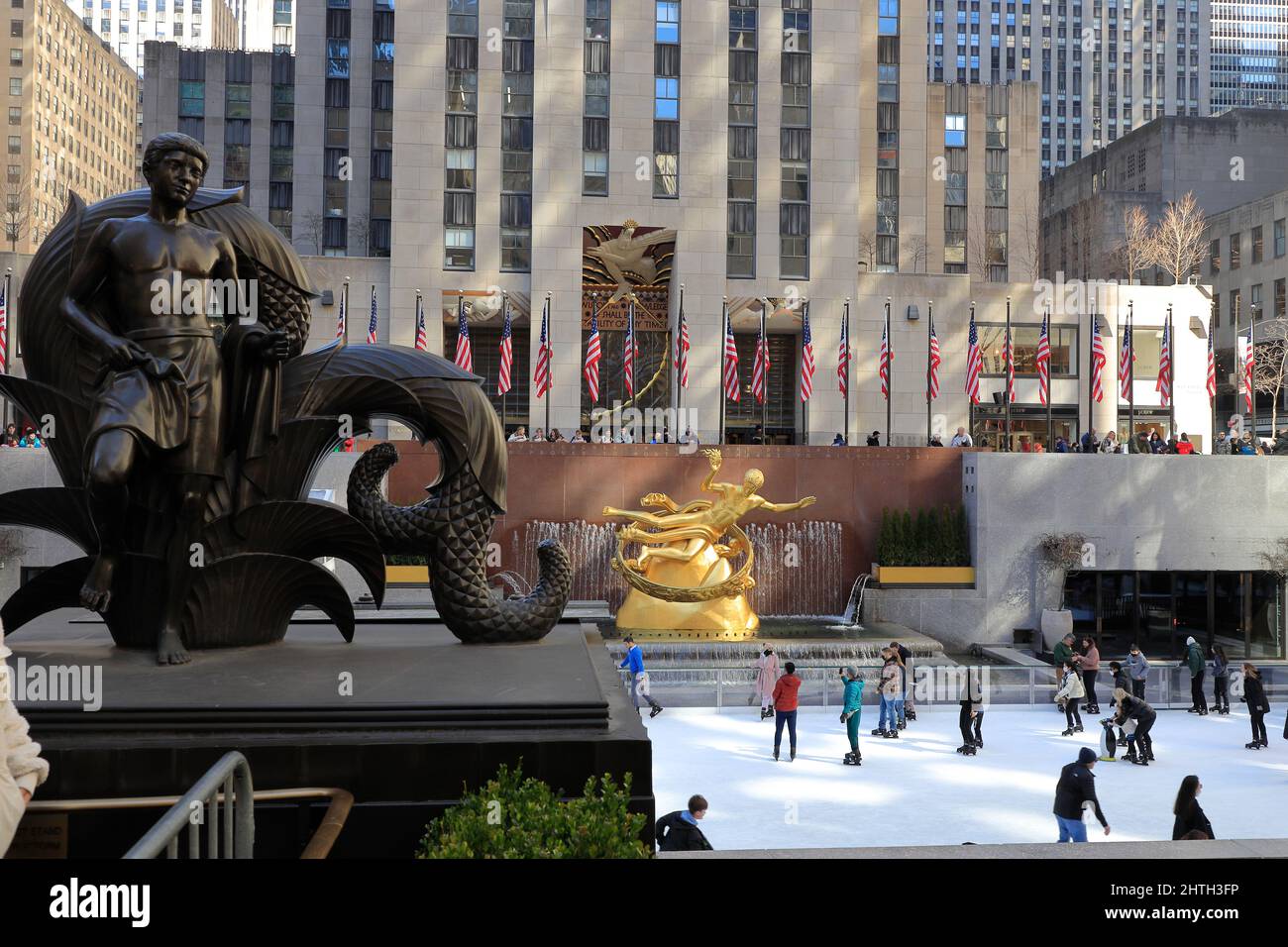 People skating in the Rink At Rockefeller Center with gilded golden ...