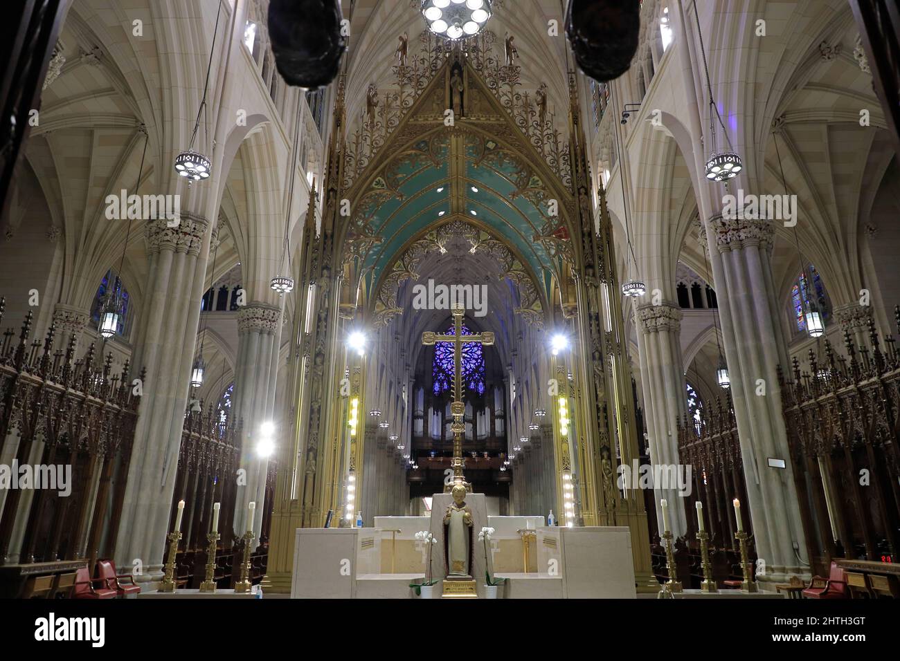 The back of the altar of St. Patrick's Cathedral with a priest giving a ...