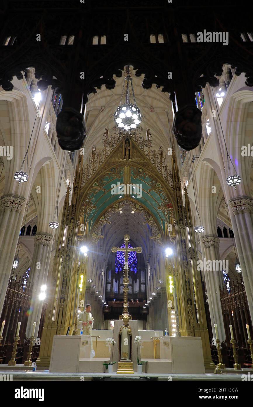 The back of the altar of St. Patrick's Cathedral with a priest giving a ...