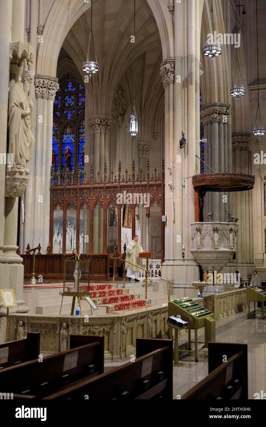 The altar of St. Patrick's Cathedral with a priest giving a mass ...