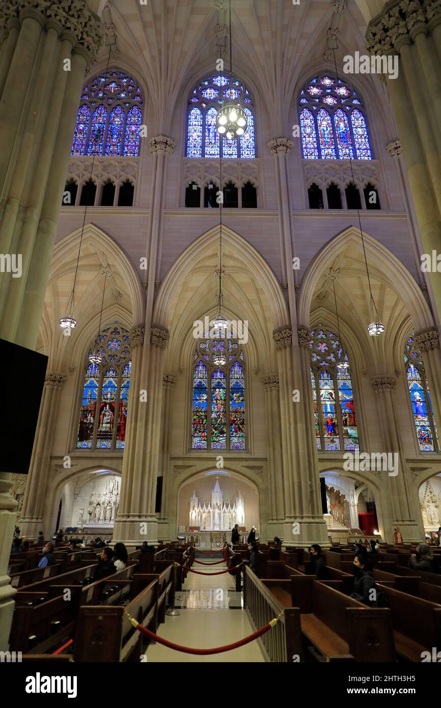Interior view of St. Patrick's Cathedral with a priest giving a mass ...
