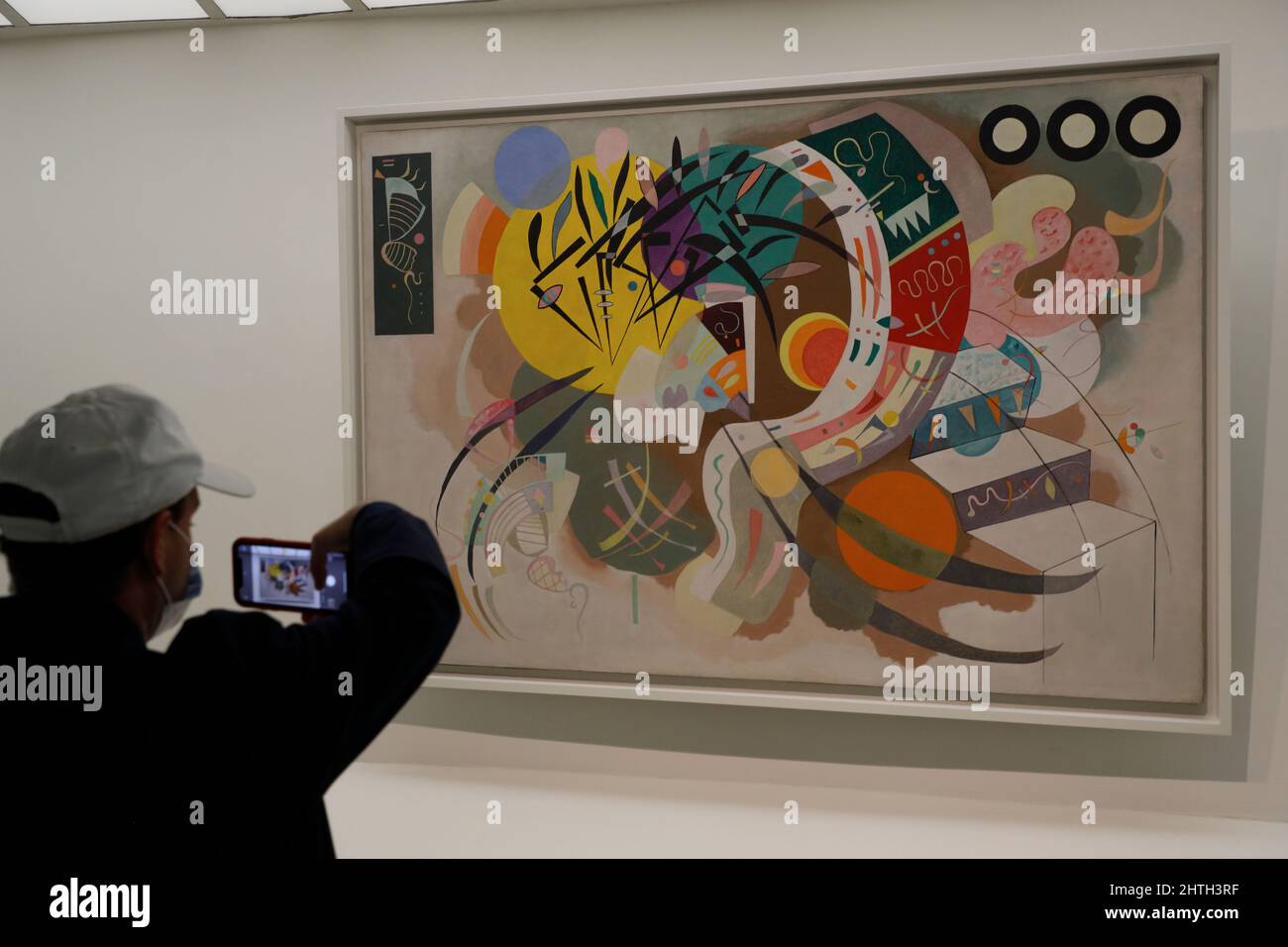 A visitor photographing Vasily Kandinsky's Dominant Curve display in ...