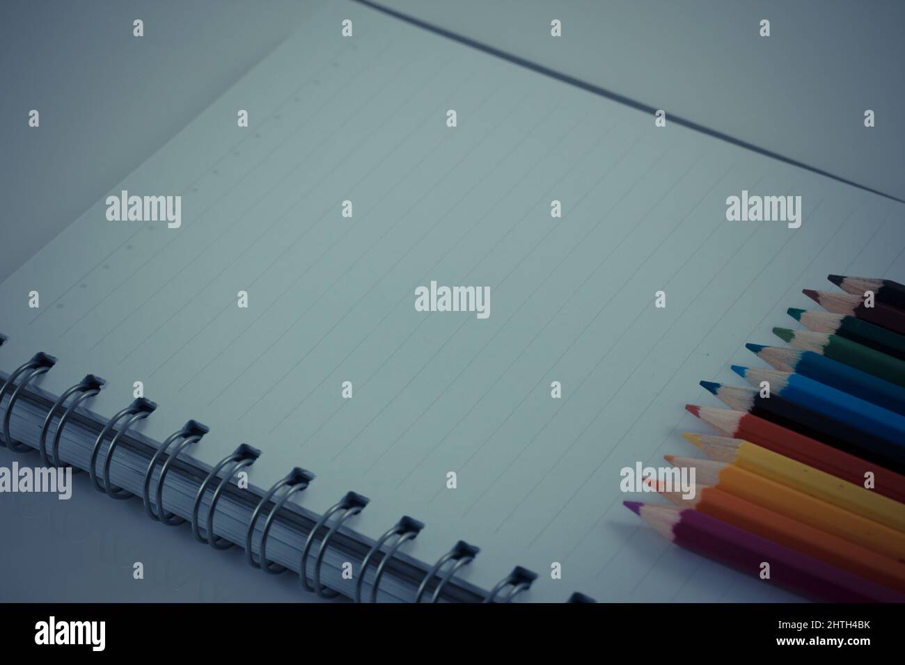 Notebook with colorful pencil on white background Stock Photo - Alamy