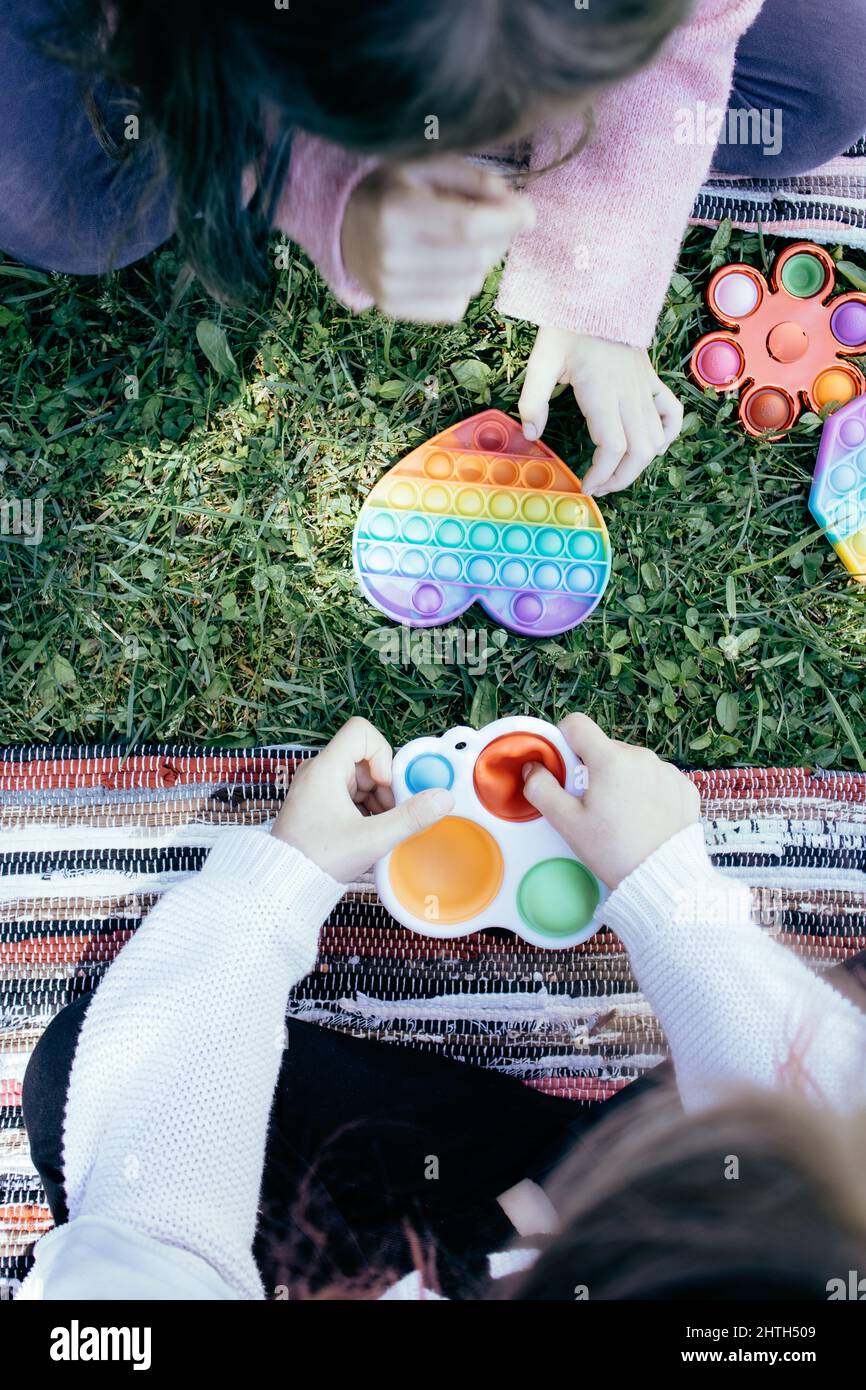 Children pull hands to pop it toys Stock Photo - Alamy