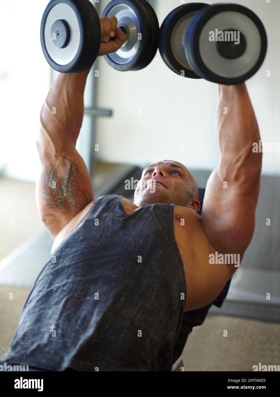Concentrating on his training session. Shot of a male bodybuilder ...