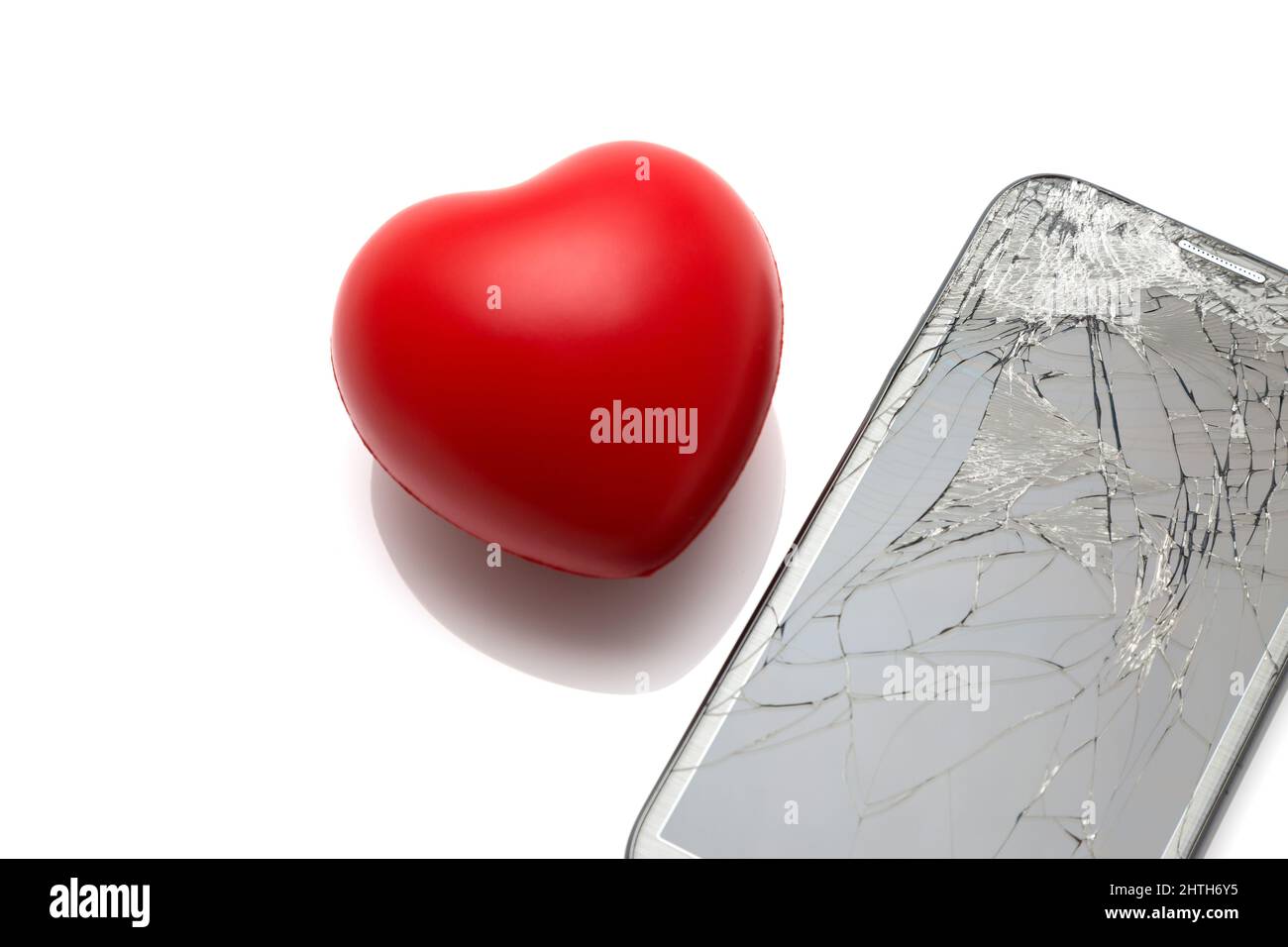 Smartphone with broken screen with red heart isolated on white ...