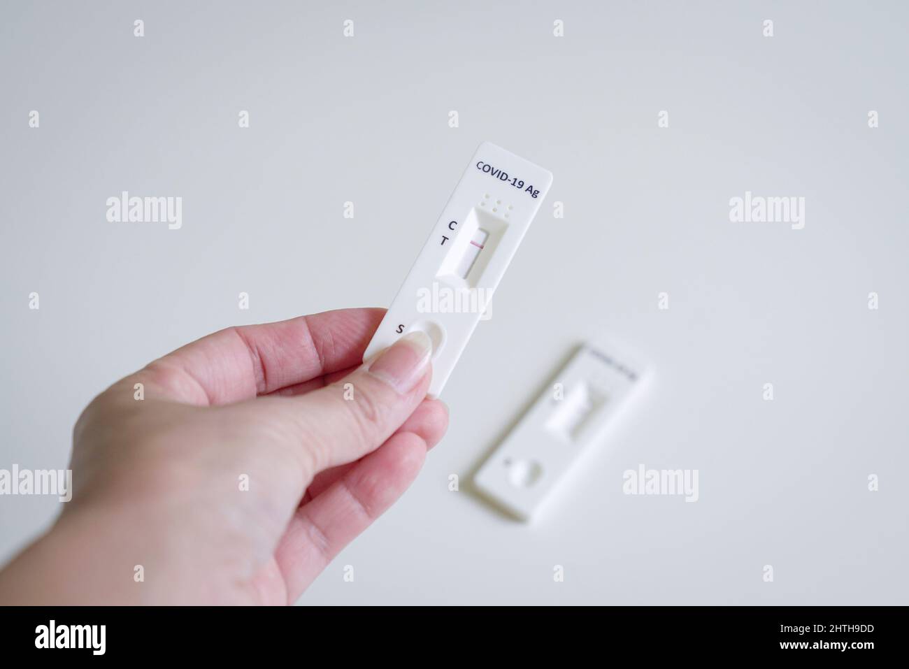 Human holding Covid-19 RTK Antigen Rapid test result. Screening method ...