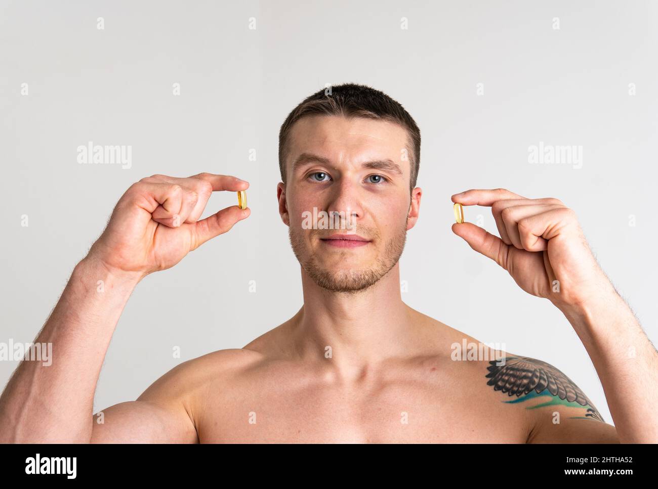 Fish oil is eaten by a man in the hands of vials and a glass bottle ...