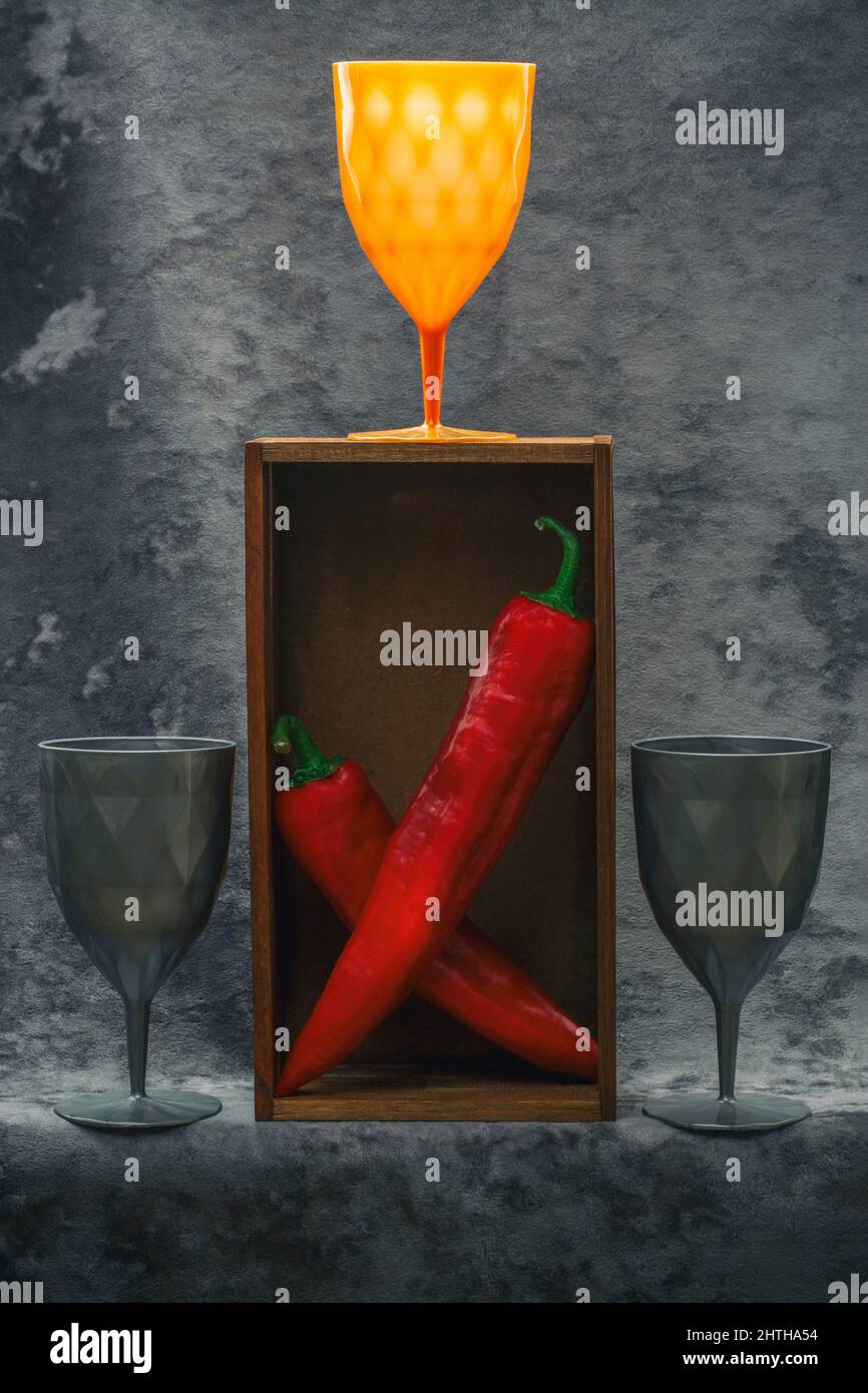 Still life with a glass and red peppers Stock Photo - Alamy
